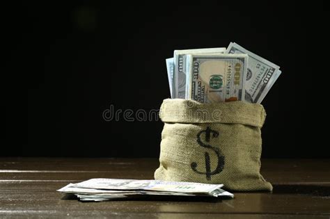 Dollar Banknotes In Sack On Wooden Table Against Dark Background Stock Image Image Of American