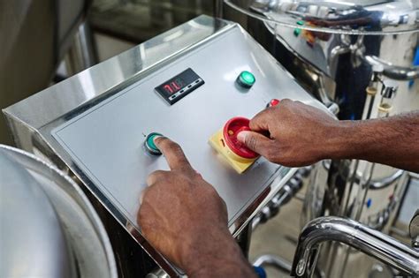 Premium Photo Worker Managing The Control Panel Of Equipment