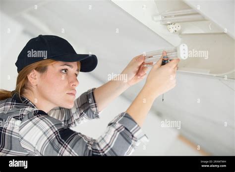 Woman Changing Light Bulb Stock Photo Alamy
