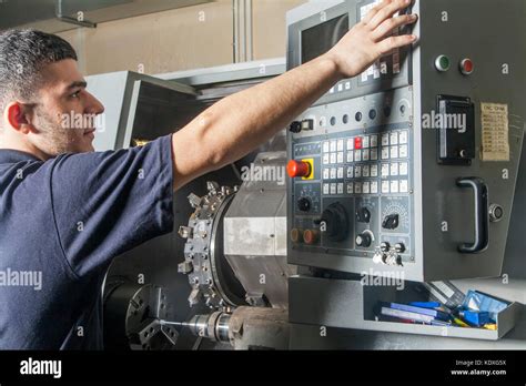 Operator Setting Up Cnc Turning Machine From Control Panel Stock Photo Alamy