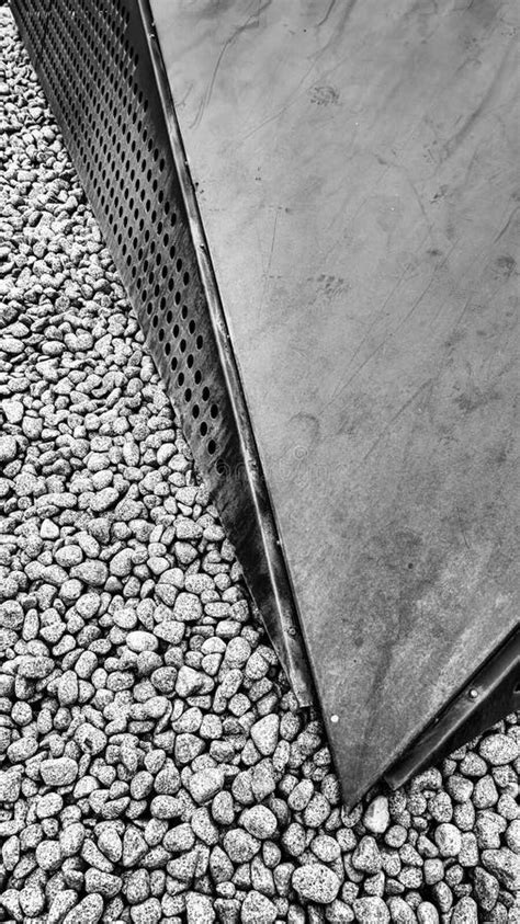 Black And White Image Of Part Of An Architectural Structure And Pebbles Stock Image Image Of