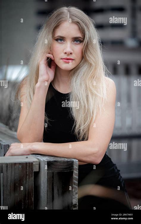 An Attractive Young Woman In Her Early Twenties Wearing A Stylish Black