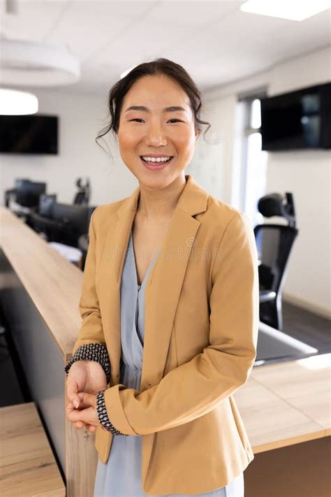 Vertical Image Of Happy Asian Businesswoman Looking At Camera In Office Stock Photo Image Of