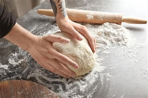 Premium Photo Woman Kneading Dough On Kitchen Table
