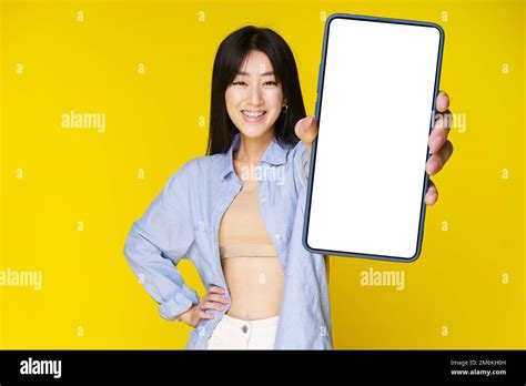 Asian Girl Holding Smartphone Showing White Screen And Excited Smile On Camera Wearing Blue