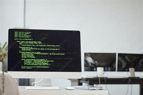 Background Image Of Pc Screen With Green Code Lines In Software Development Office Interior