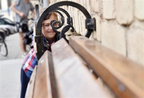 Premium Photo Cute Girl Playing With Bench In City