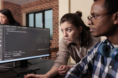 tech enginner asking app designer for help with html code stock image