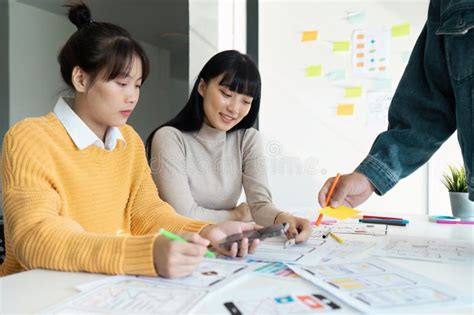 Creative Team Collaborating On Ux Ui Design Project With Wireframes And Prototypes Stock Image