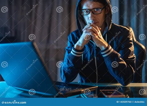 Male In The Hood Looking In The Camera Hacker Attacks And Stealing Access Databases With