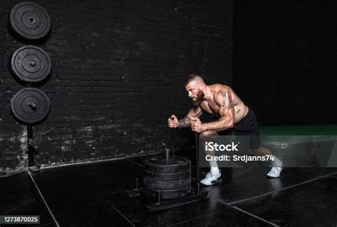 젊은 강한 땀근육 에 맞는 남자 큰 근육 하드 코어 크로스 운동 훈련으로 체육관에서 배회 자 슬라이더에 무거운 무게 플레이트를 밀어 운동에 대한 스톡 사진 및 기타 이미지