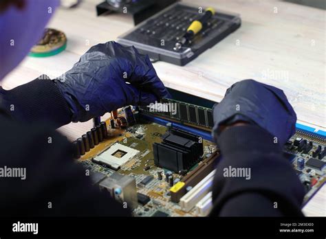 Inserting Ram Into Motherboard From Computer On Table And Gray