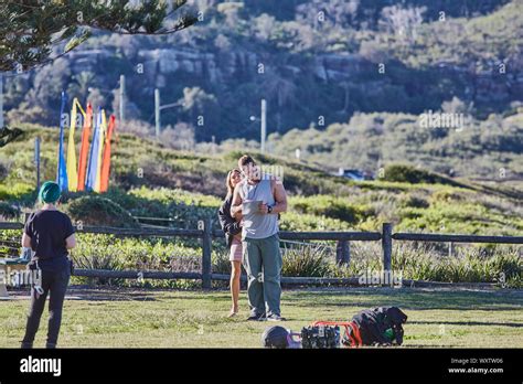 Actors Jake Ryan Sam Frost And A Member Of The Crew Prepare To Film An Outdoor Scene Of Home