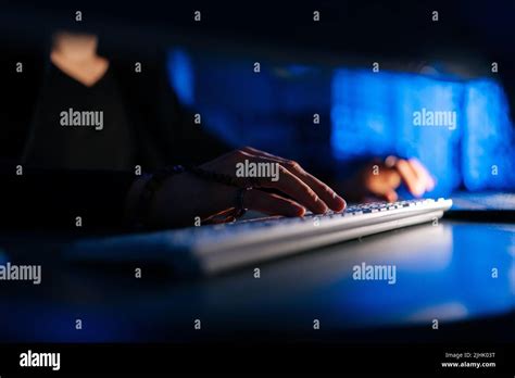 close up hands of unrecognizable hacker man working typing on keyboard laptop computer sitting