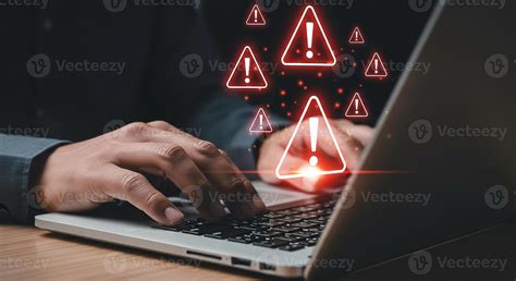 Person Working On Laptop Computer With Warning Signs Appearing