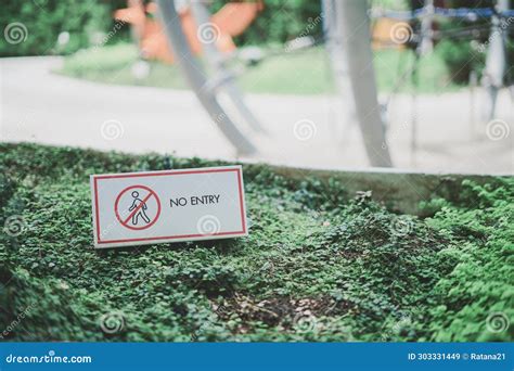 No Entry Sign On Green Grass In Soft Focus Public Area Stock Image