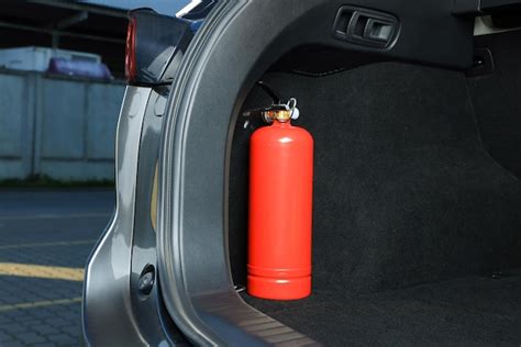 Premium Photo Red Fire Extinguisher In Trunk Space For Text Car