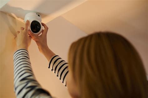 Premium Photo Woman Installing Security Camera