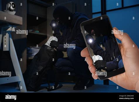 Man Monitoring Situation At His House With Cctv App On Smartphone Closeup Thief Stealing Money