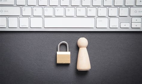Premium Photo Human Wooden Figure With A Padlock And Computer Keyboard