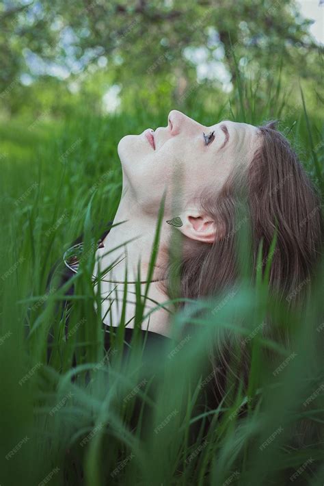 Premium Photo Close Up Woman In Tall Grass Looking Up At Sky Portrait