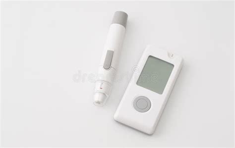 Blood Glucose Meter And Lancet Pen On White Background Used For