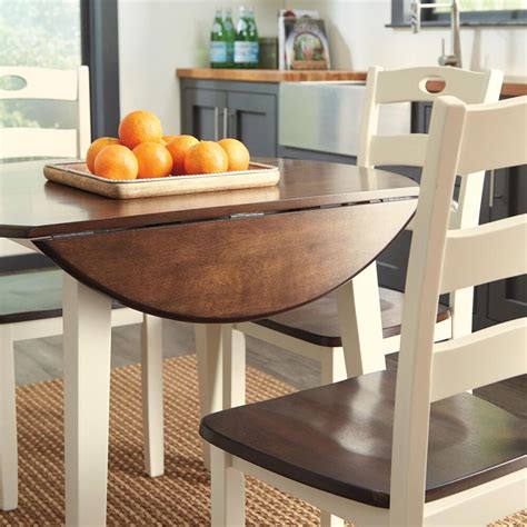 Ashley Woodanville Round Dining Table With 2 Drop Leaves In Cream And