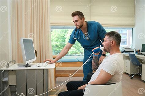 Adult Man Taking Spirometry Test In Presence Of Doctor Stock Image