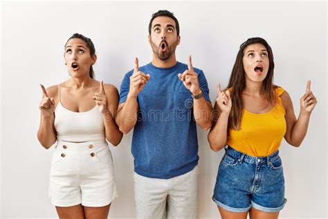Group Of Young Hispanic People Standing Over Isolated Background Amazed