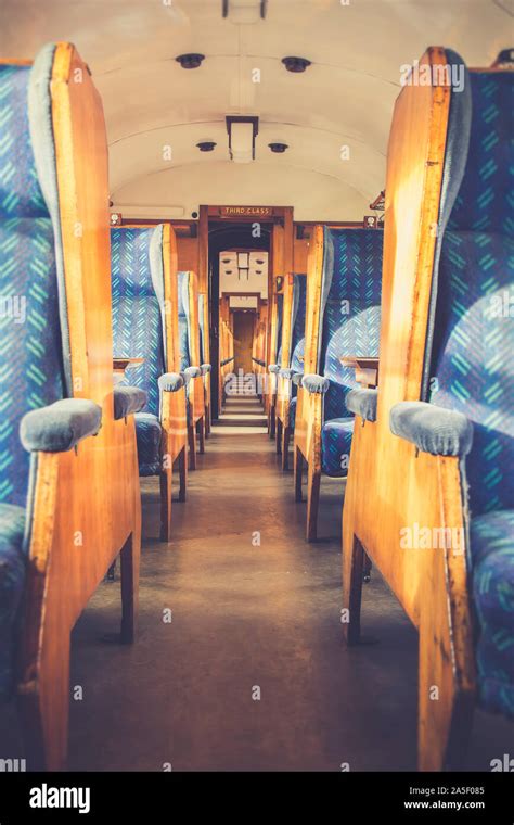 Retro Interior View Of Empty Uk Vintage Railway Carriage Lit By Autumn