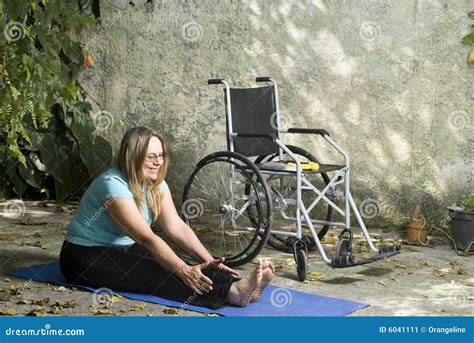 Woman Stretches Next To Wheelchair Vertical Stock Image Image Of