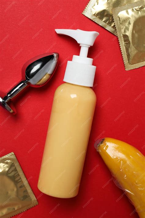 Premium Photo Lubricant Banana And Condoms On A Red Background