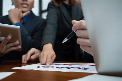 Premium Photo Business People Analyzing Graphs On Table