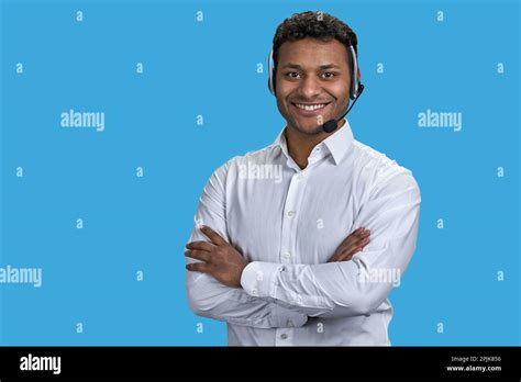 Portrait Of Indian Man With Folded Arms Wearing Headset Isolated On