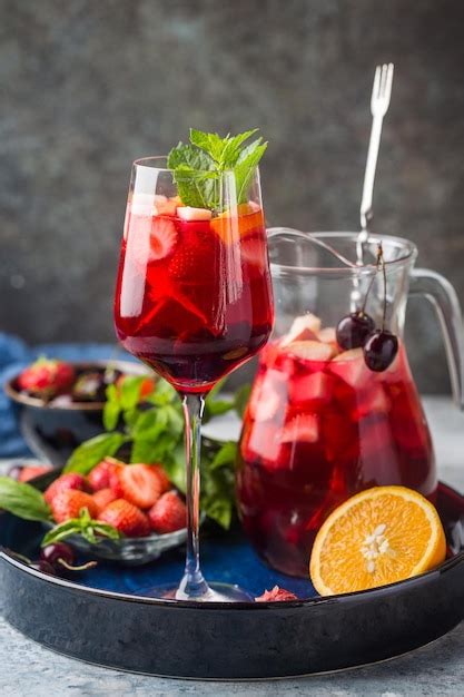 Premium Photo Red Wine Sangria Or Punch With Fruits And Ice In