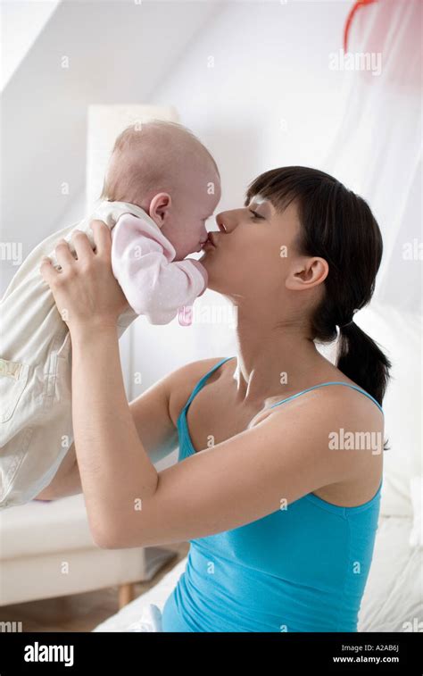 Mother Kissing Her Baby Stock Photo Alamy