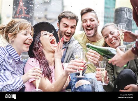 Group Of Happy Friends Doing Party Throwing Confetti And Drinking Champagne Outdoor Young