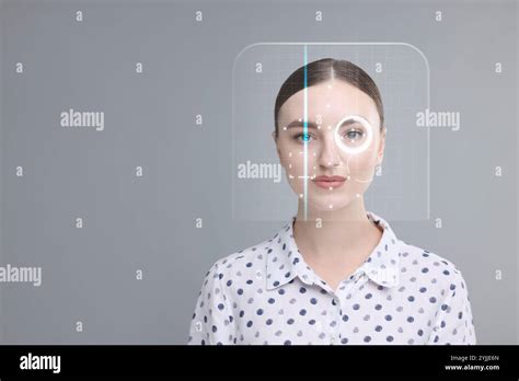 Facial And Iris Recognition System Woman Undergoing Biometric Verification On Grey Background