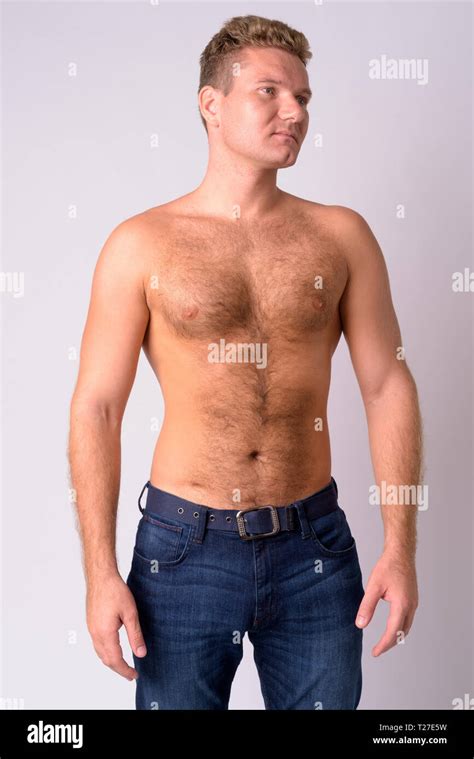 Portrait Of Young Blonde Shirtless Man With Chest Hair Thinking Stock