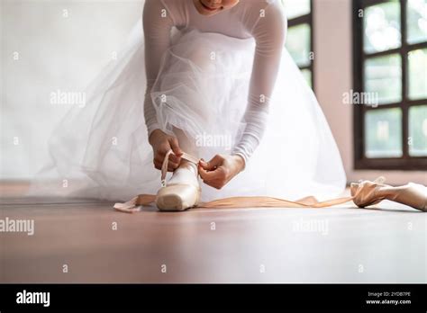 Ballerina In Ballet Shoes Asian GirlÂ Tying Ribbons Of Toe Shoes Ballet Dancer Preparing And