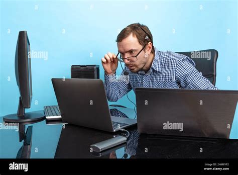 portrait of concentrated man programmer computer system analyst working with operating sytem