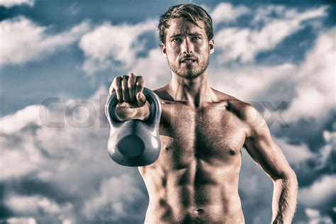 Fit Man Training Lifting Kettlebell Weight Bodybuilding With Muscular Chest And Abs Topless