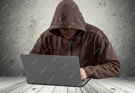 Premium Photo Hacker Typing On A Laptop With Binary Code In Background