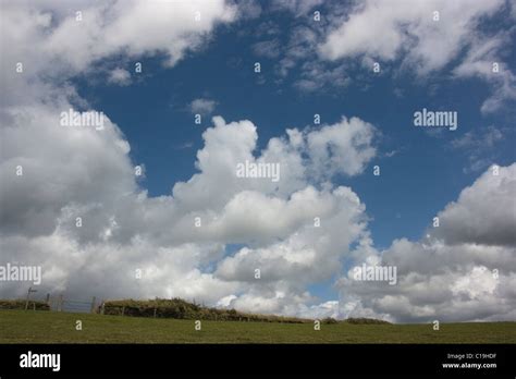 Cumulous Clouds In Blue Sky Above Meadow Croyde North Devon Stock