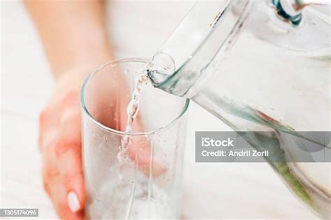 한 여성이 용기에서 유리로 신선하고 맑은 물을 붓고 있습니다 건강과 다이어트 개념 건강을 위해 깨끗한 물 가득 찬에 대한 스톡 사진 및 기타 이미지 Istock