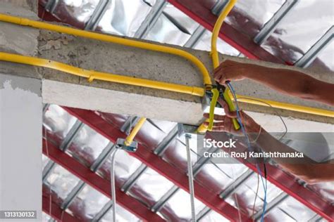 전기 사람 작동 와이어 커터와 와이어 전원 케이블을 설치합니다 천장 시멘트 빔에 전기 금속 상자를 연결하는 전문 기술자 노동자 설정 0명에 대한 스톡 사진 및 기타 이미지