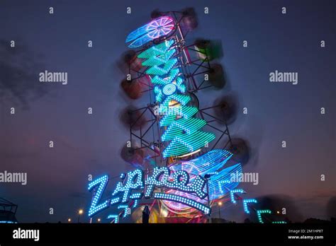 Zipper Carnival Ride With Blurred Lights During Dusk At County Fair