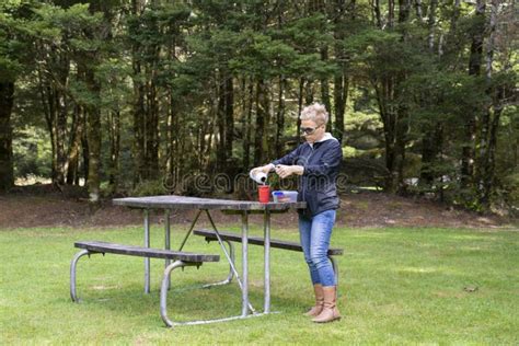 Women Is Making Coffee On The Picnic Table Pleasant Flat Campsite