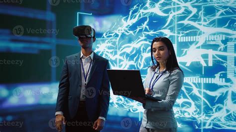Technician Wearing Vr Headset Looks At Hologram Of Artificial Intelligence Human Brain