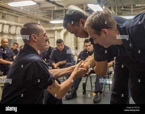 Chief Master At Arms Trains Sailors In Hand To Hand Combat Aboard Uss